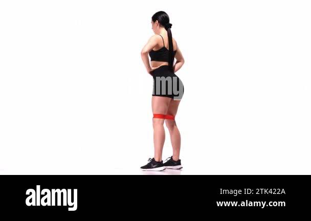 Complex exercises on legs and buttocks. Young sportive girl training with fitness elastic bands ...