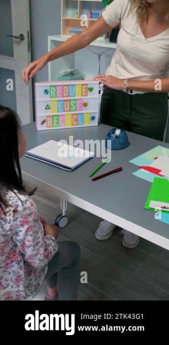 Unrecognizable female teacher using led lightbox with text reduce ...