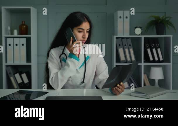 Doctor radiologist young woman surgeon explore x-ray scan MRI result ...