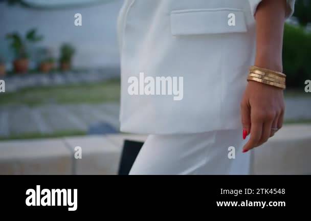 Unrecognizable luxurious girl walking urban street wearing stylish ...