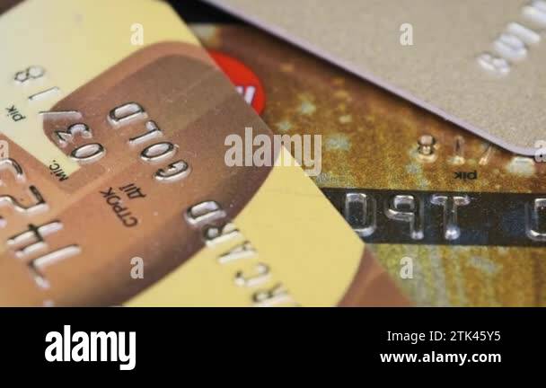 Debit card rotates close-up. Golden credit card with chip and numbers ...