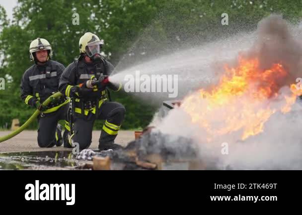 Firefighters fight the fire flame to control fire not to spreading out ...