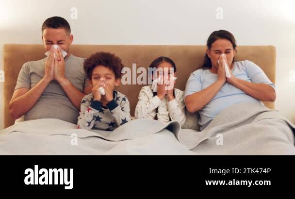 Sick, bed and family blowing their nose while relaxing together with a ...