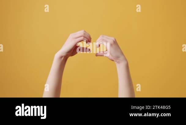 The heart symbol created by a girls hand. shape made by the fingers of ...