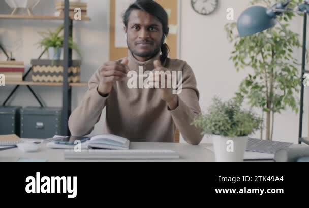 Portrait of Indian man making online video call from office speaking ...
