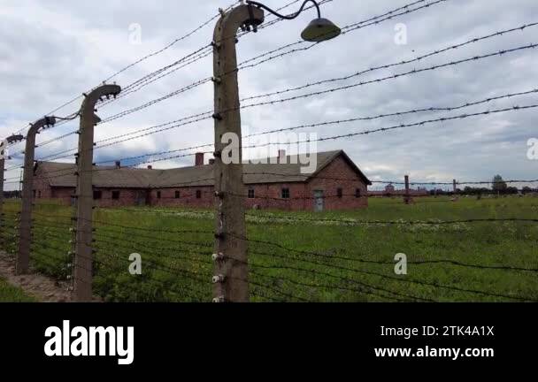 Camp Barracks Behind Barbed Wire Fencing At The Former Nazi German ...