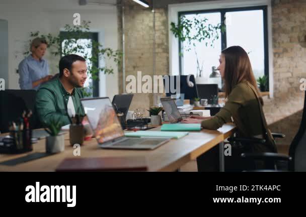 Female ceo checking employees work process in modern company office ...