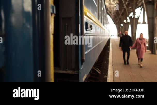 A young couple in love hug and say goodbye before the girl gets on the ...