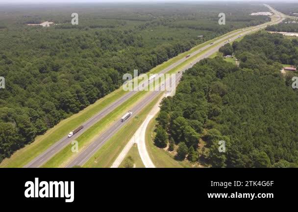 Fly over busy traffic on Highway Interstate 10 (I-10) with two lanes of ...