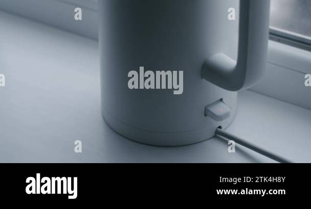 Water boils. Button for turning on the electric kettle for boiling ...