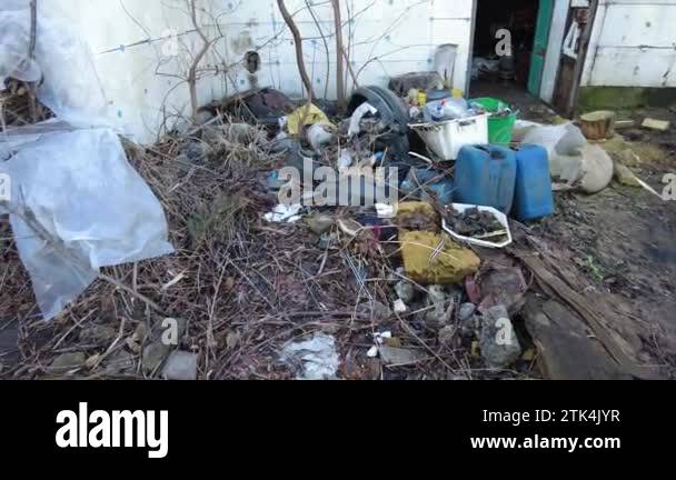abandoned house in Ukraine. Rubbish in the yard. destroyed house ...