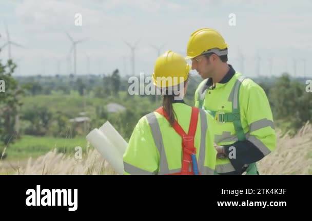 Smart professional engineers working in fieldwork outdoor. Workers ...