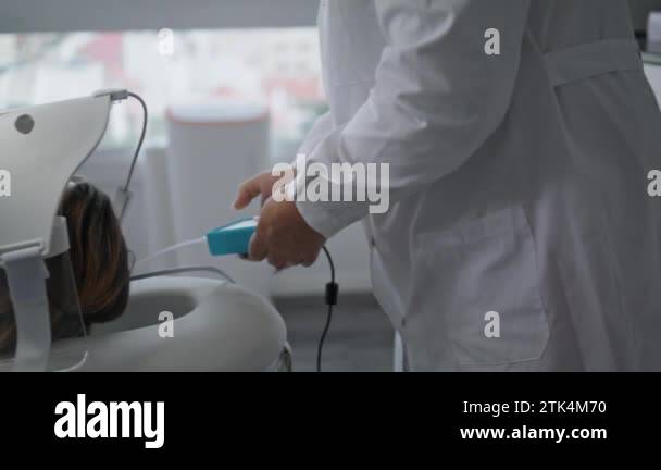 Unknown professional cosmetologist applying facial treatment led mask ...