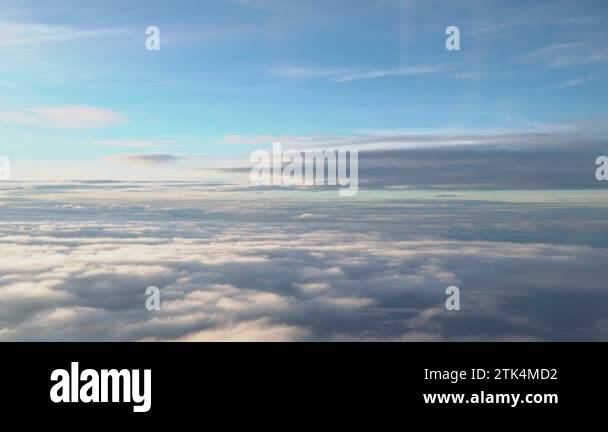 View from the window of an airplane.White clouds floating in layers ...