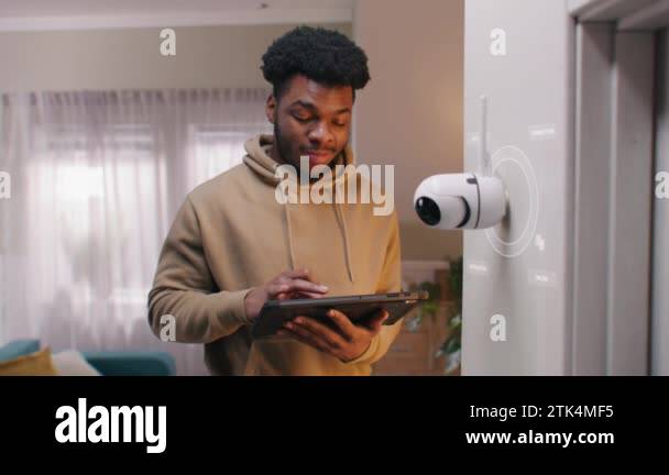 African American man sets up security camera with AI recognition at ...
