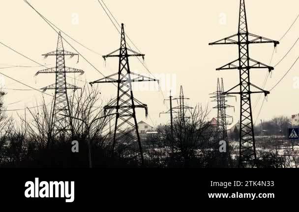 A lot of high-voltage poles with electrical wires against the ...