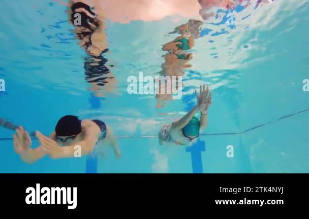 Woman athlete swims underwater in the pool. Slow motion of a female ...