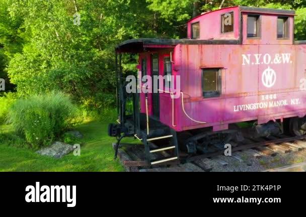 This video shows a view of a red caboose. A caboose is a railroad car ...