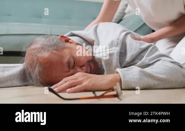Dizziness elderly old man falling down lying on floor with walking stick and assistant nurse ...