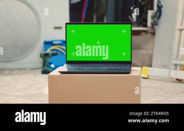 Green screen laptop in front of malfunctioning outdoor condenser. Mock ...