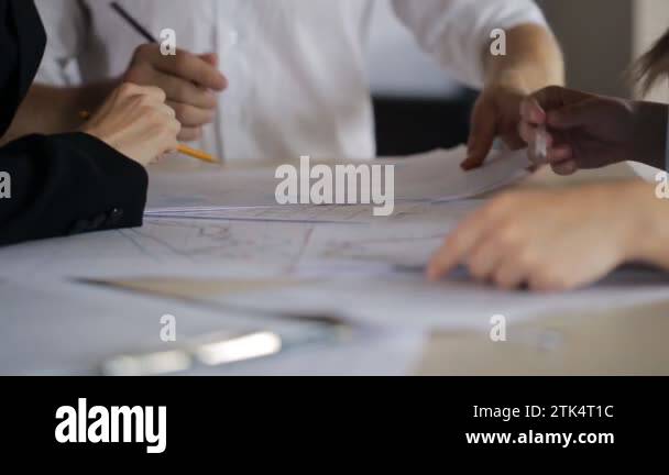 Active discussion of charts and plans on paper with your hands and ...