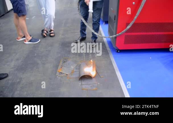 Process of laser cleaning of metal surfaces. Man cleaning surface from ...