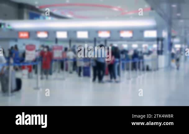 out of focusing blurred of crowded people passenger lines in airport ...