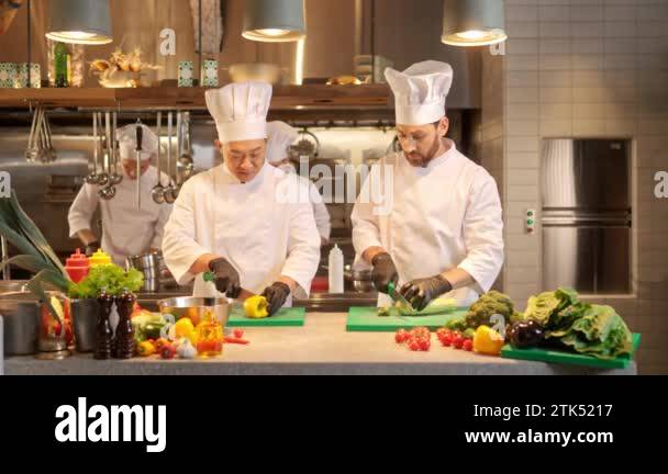 Two multicultural chefs communicate at workplace on background of ...