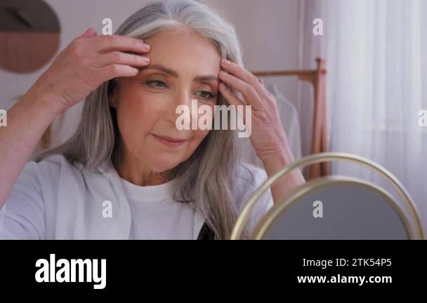 Closeup Caucasian senior mature lady old 50s woman female looking at ...
