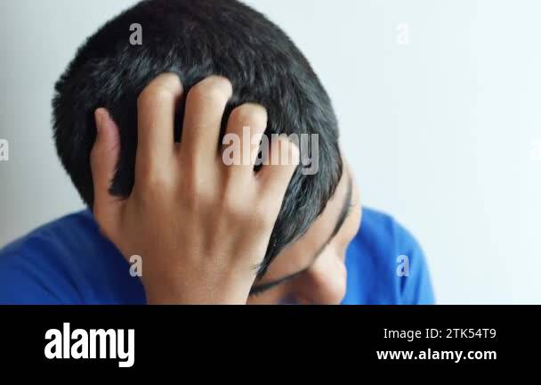 teenage boy Scratching Head Against black background Stock Video ...