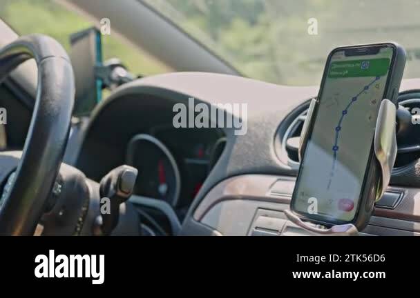 GPS navigation in car with man driving 4K. Close up on navigation ...