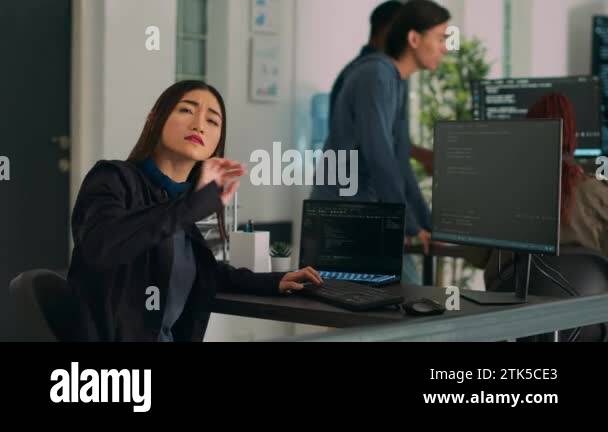 Asian Coder Turning Head To Work With Holographic Server Code Typing Html Script On Terminal