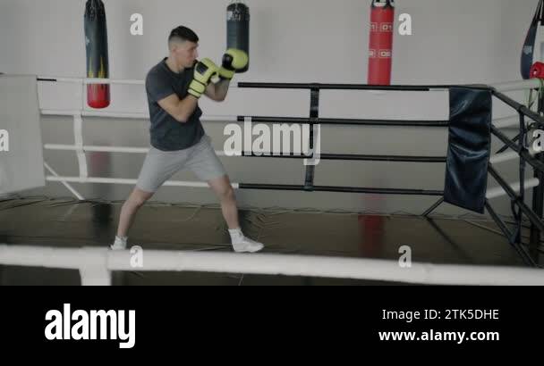 Full body portrait of muscular man training in boxing ring wearing ...