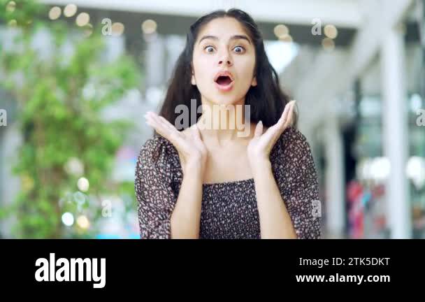 Young indian woman wearing a dress afraid and shocked with surprise ...