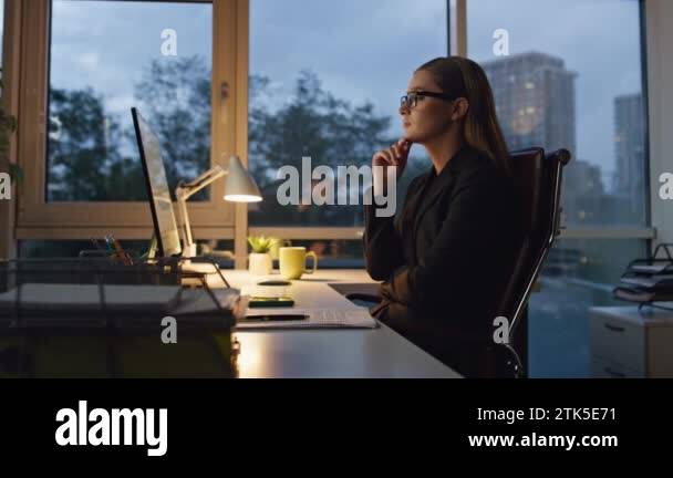 Successful entrepreneur working night in office. Focused woman ...