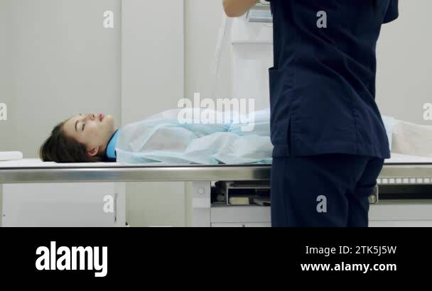 Female patient on X ray machine. Pan left and right view of woman in ...