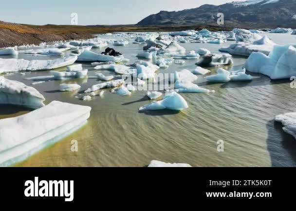 Large Chunks of Ice Float in Brown Glacier Lagoon in Iceland Global ...