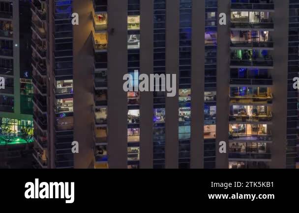Light in windows of modern towers. Exterior of apartment building at ...