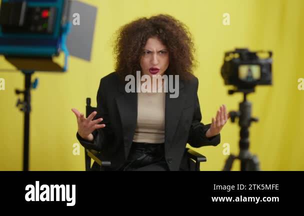 Beautiful woman talking with irritated facial expression filming video ...