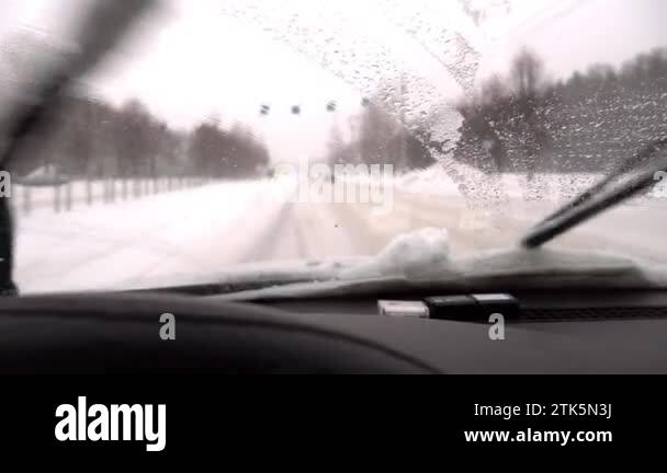 Driving in snow storm. Poor visibility through driver's glass onto road ...