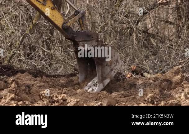 Working with backhoe by digging ground at construction site. Excavator ...