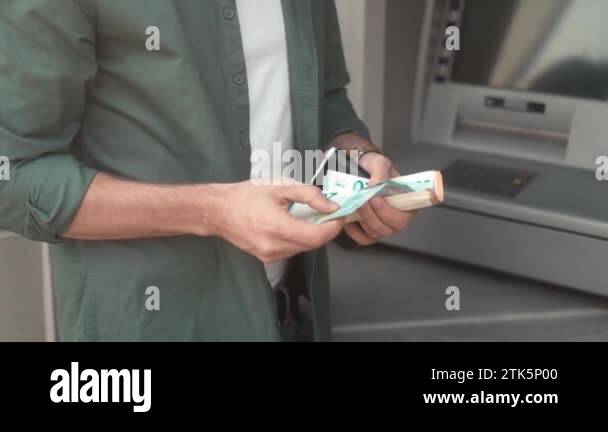 Close-up view of caucasian man receiving euro notes from debit bank ...