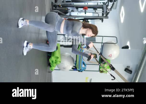 A beautiful girl trains the muscles of the buttocks, she performs ...