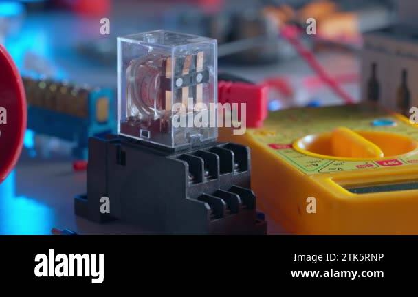 Yellow multimeter and relay with electromagnetic coils of direct and ...