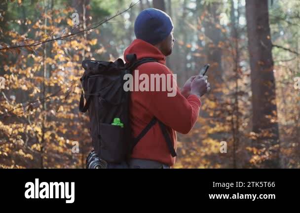 Outdoor mapping in hike. Man hiker uses smartphone to navigate in ...