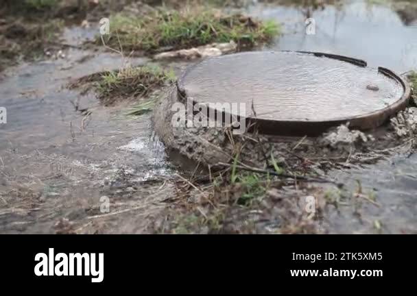 Water flows out of the manhole. The accident in the sewer Stock Video ...