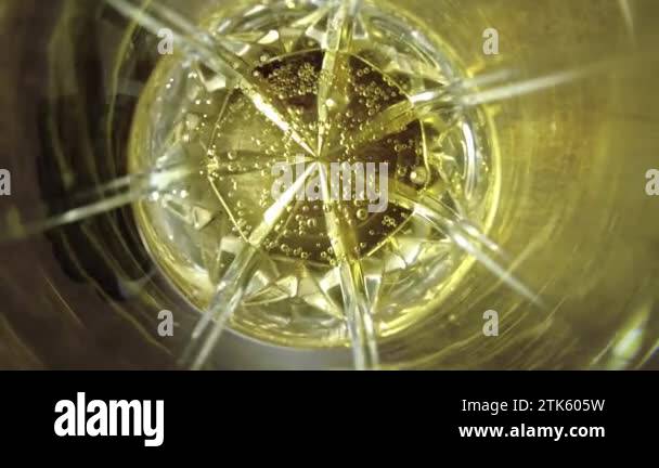 lemonade in a transparent glass. 4k footage. Pouring a carbonated drink into a glass close up ...