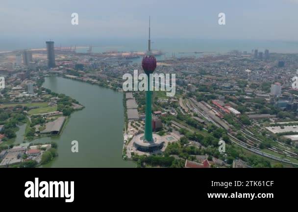 Aerial view of tall TV tower above urban boroughs. Lotus tower and ...