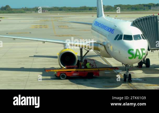 commercial aircraft at airport with SAF text and zero emissions ...