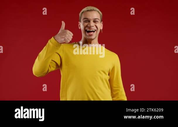 Handsome man makes hand sign like, thumb up gesture. Happy guy, correct ...